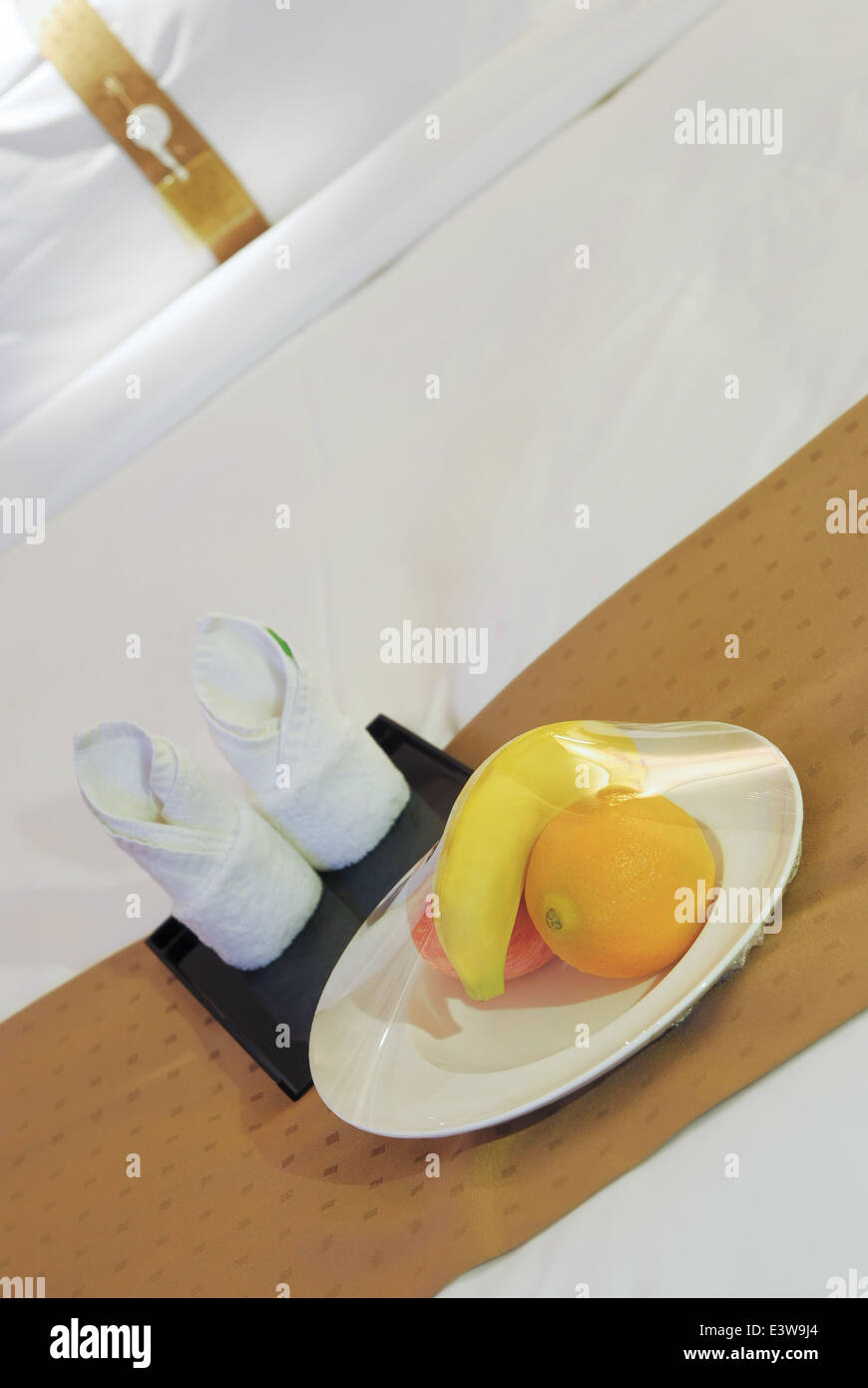 towels and fruit on bed in a hotel room Stock Photo - Alamy
