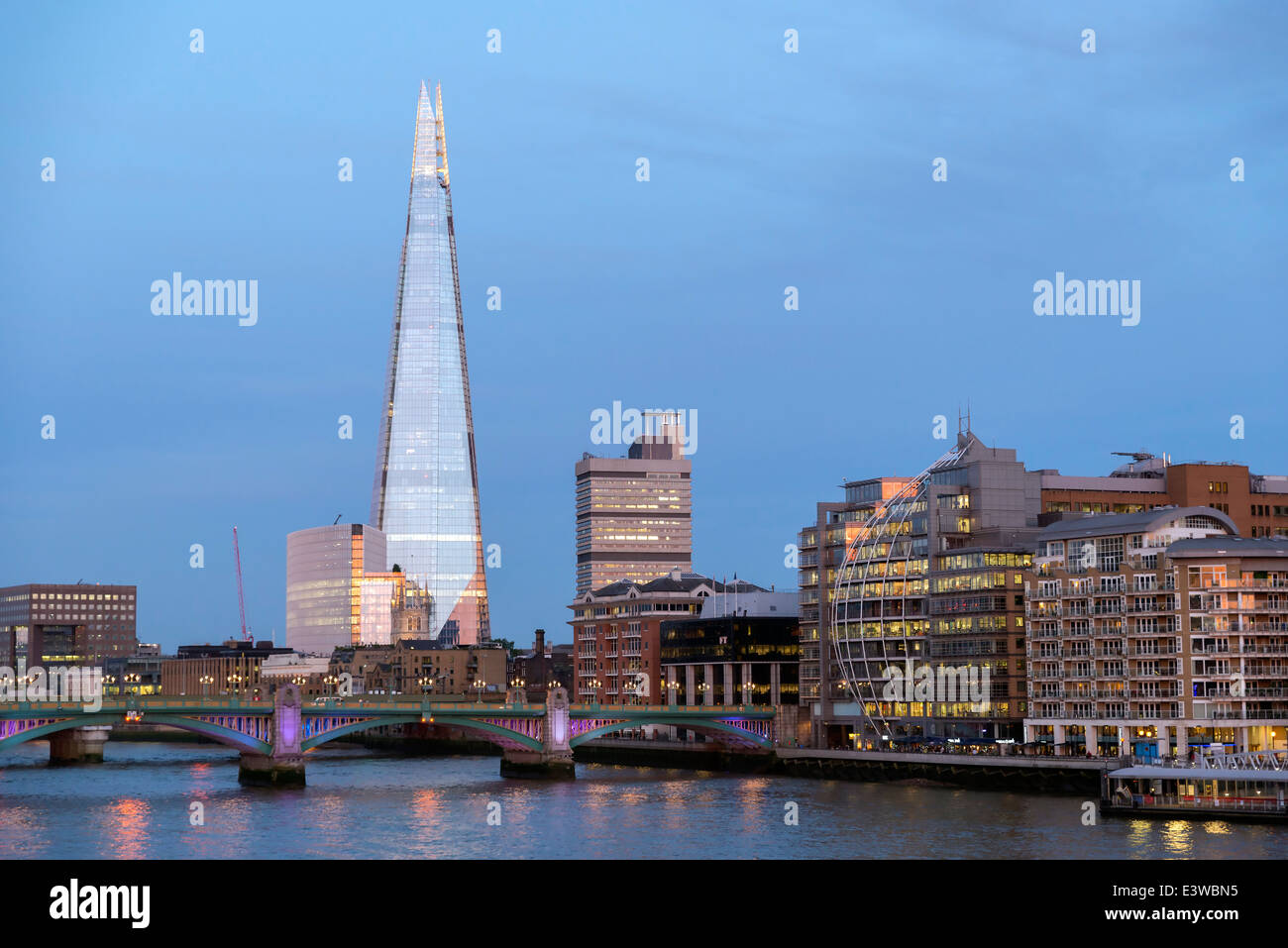Late afternoon sun lights up the London skyline. The Shard is the ...