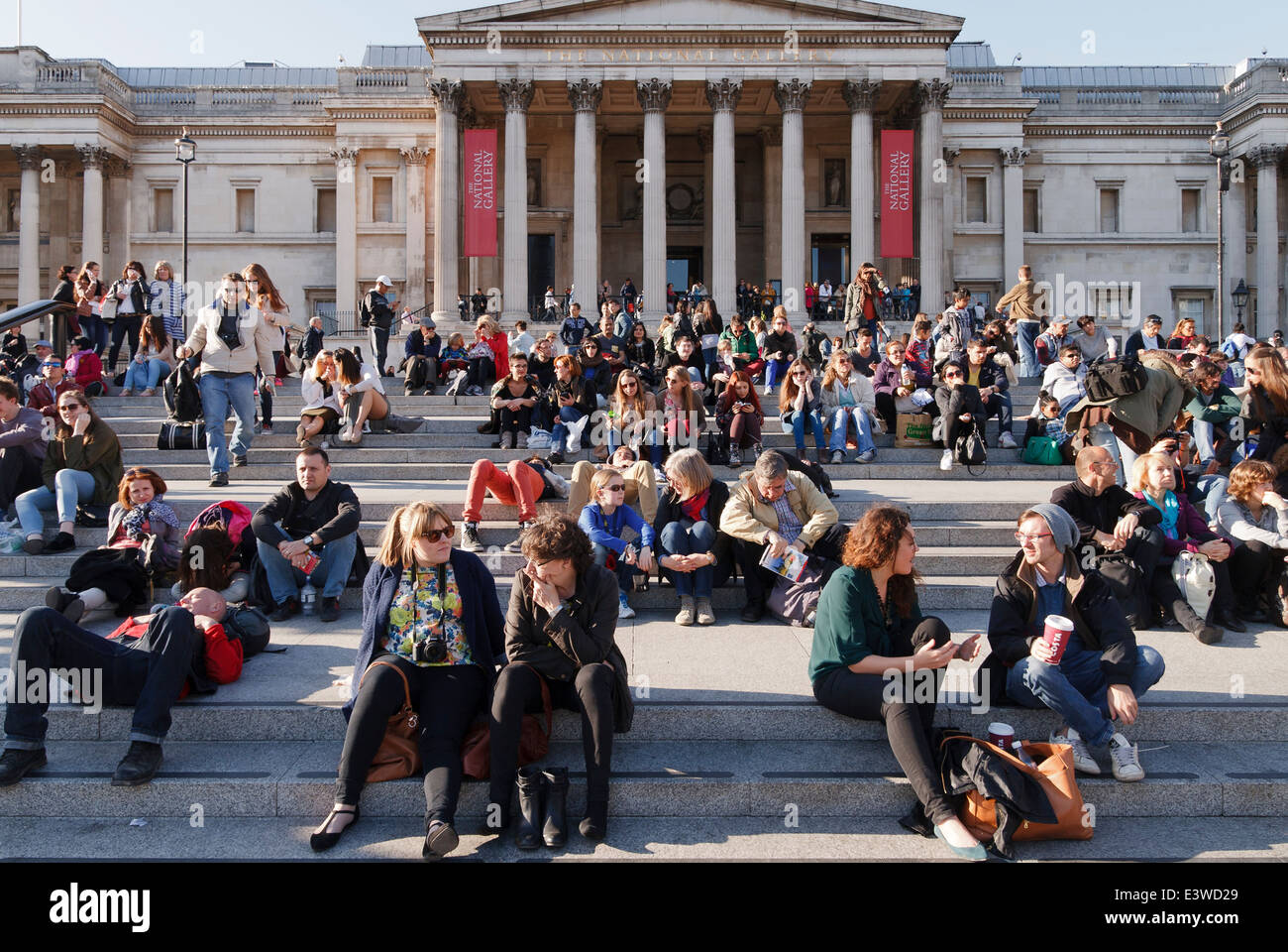 Crowd of tourists resting on steps of London's National Gallery on a ...