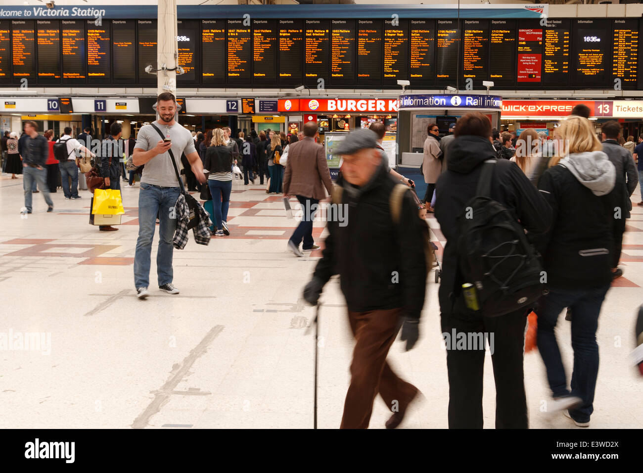 Good looking young man, with beard, smiling broadly whilst reading a ...