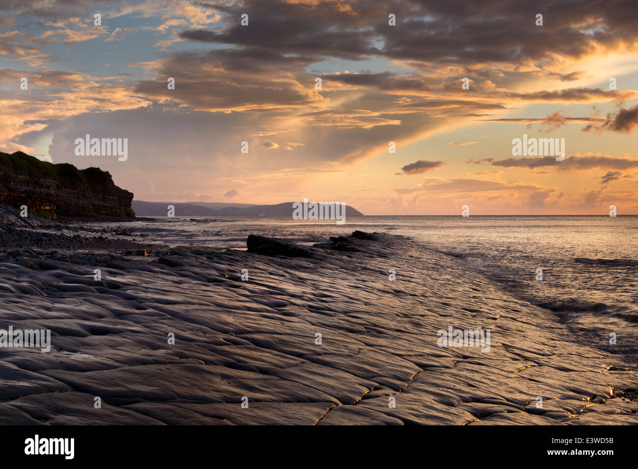Limestone slab exposed by falling tide on a summer's evening. Beach ...