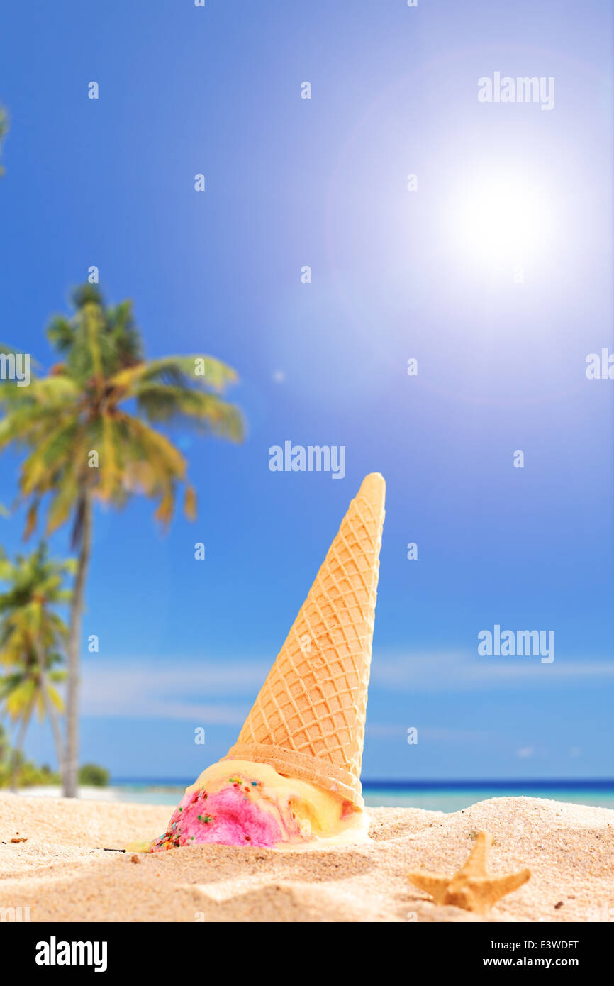 An ice cream melting in the sand on a tropical beach on sunny day Stock ...