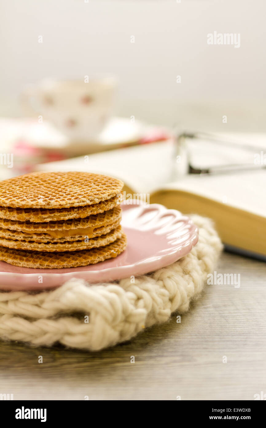 Dutch Syrup Waffles (Stroopwafels) on a pink plate with an open book ...