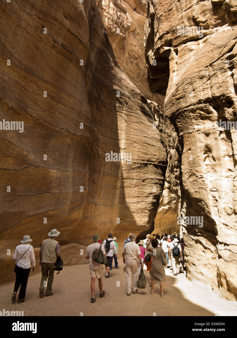 Jordan, Arabah, Petra, tourists walking through Al-Siq entrance canyon ...