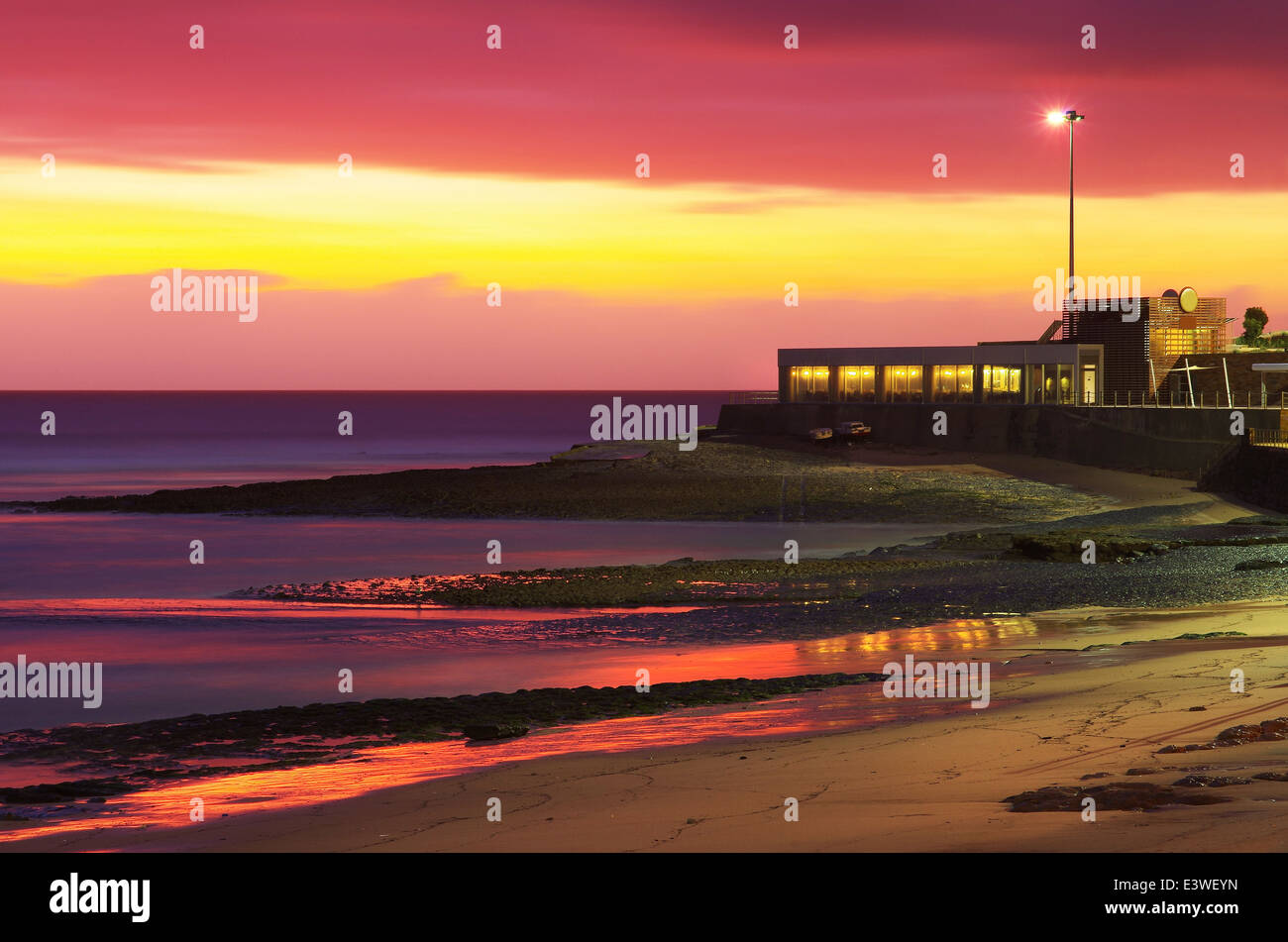 Landscape with a restaurant on the beach, in a beautiful sunset light ...