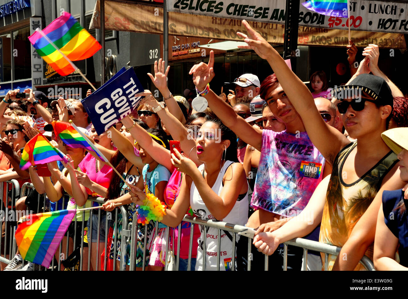 NYC: Exuberant crowds waving rainbow flags watching the 2014 Gay Pride ...