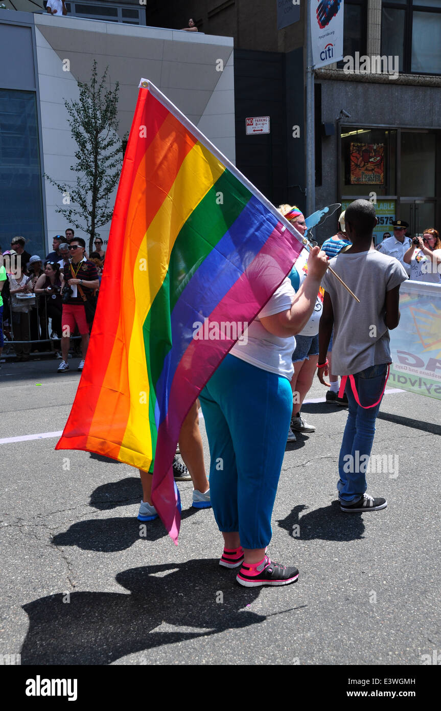 Nyc Woman Carrying A Large Rainbow Flag Marching In The 2014 Gay Pride