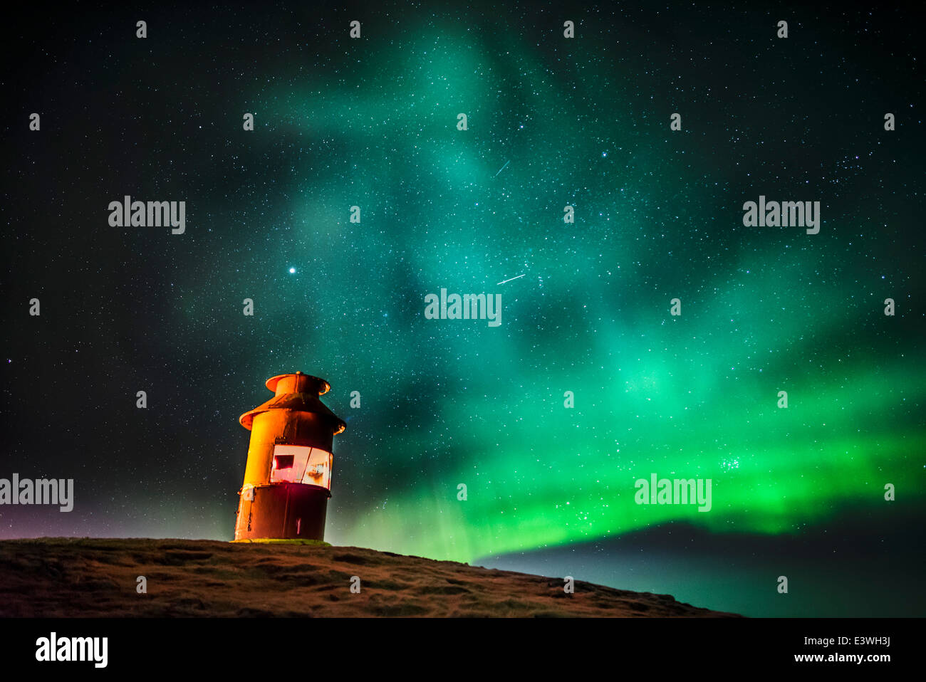 Lighthouse with Aurora Borealis or Northern Lights, Iceland Stock Photo ...