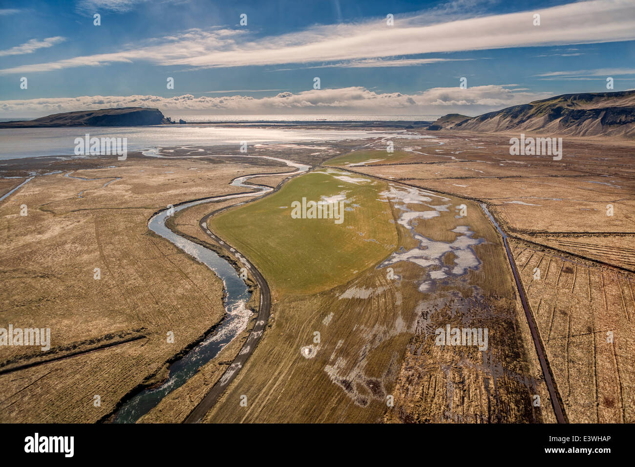 Aerial view of rivers and farmland with Dyrholaey and Reynisdranger ...