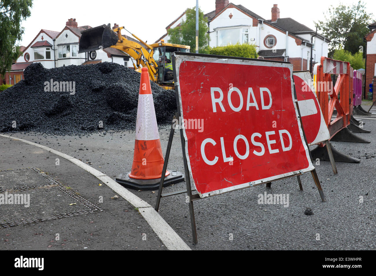 a road is closed as resurfacing work is being done to reair road ...