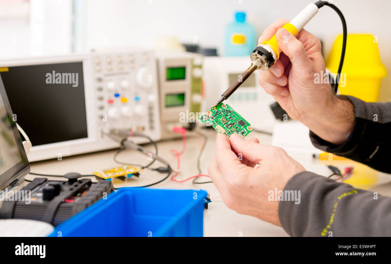 repair and adjustment of the electronic device Stock Photo - Alamy