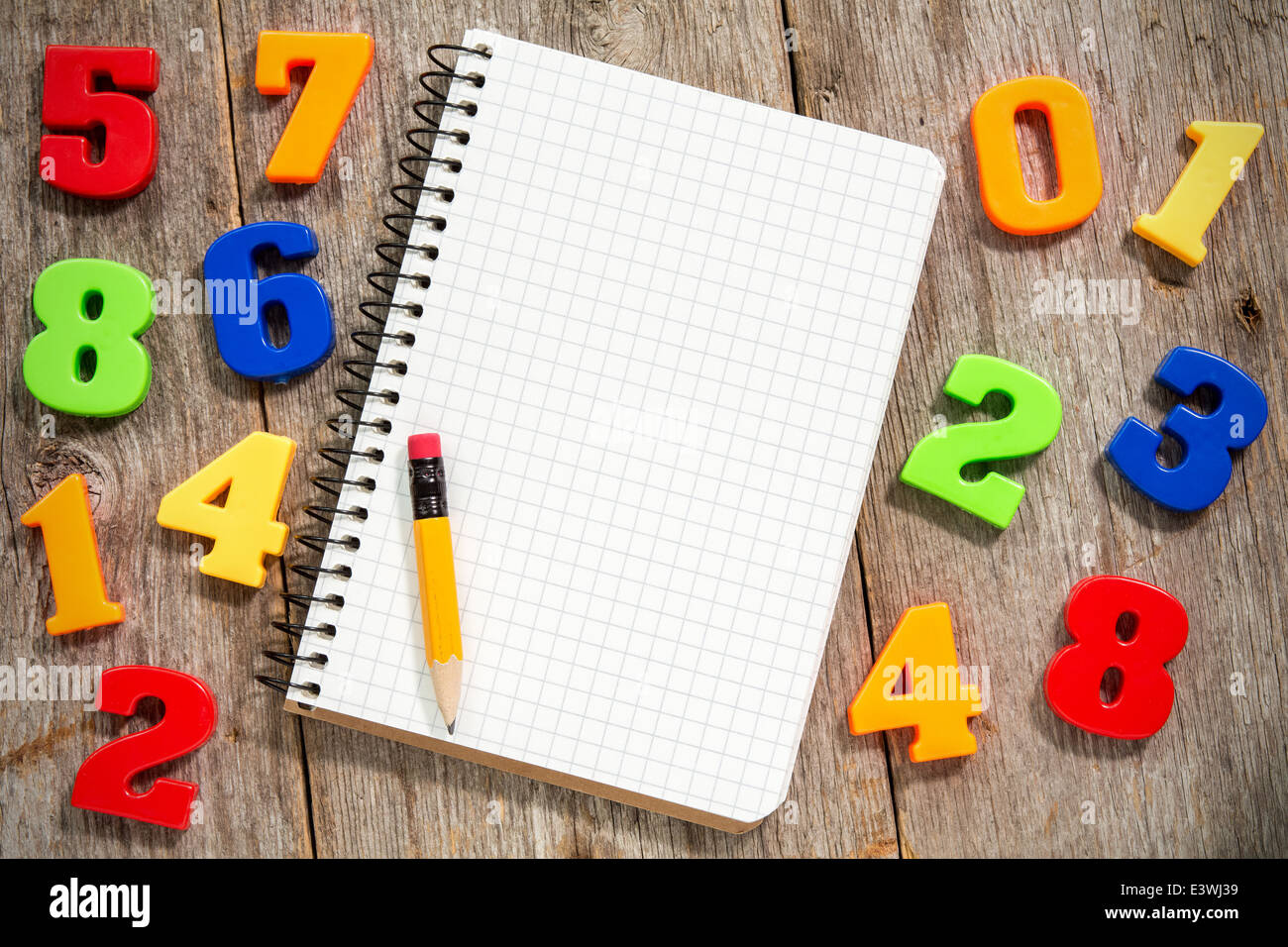 Colorful plastic numbers and empty notebook with pencil Stock Photo - Alamy