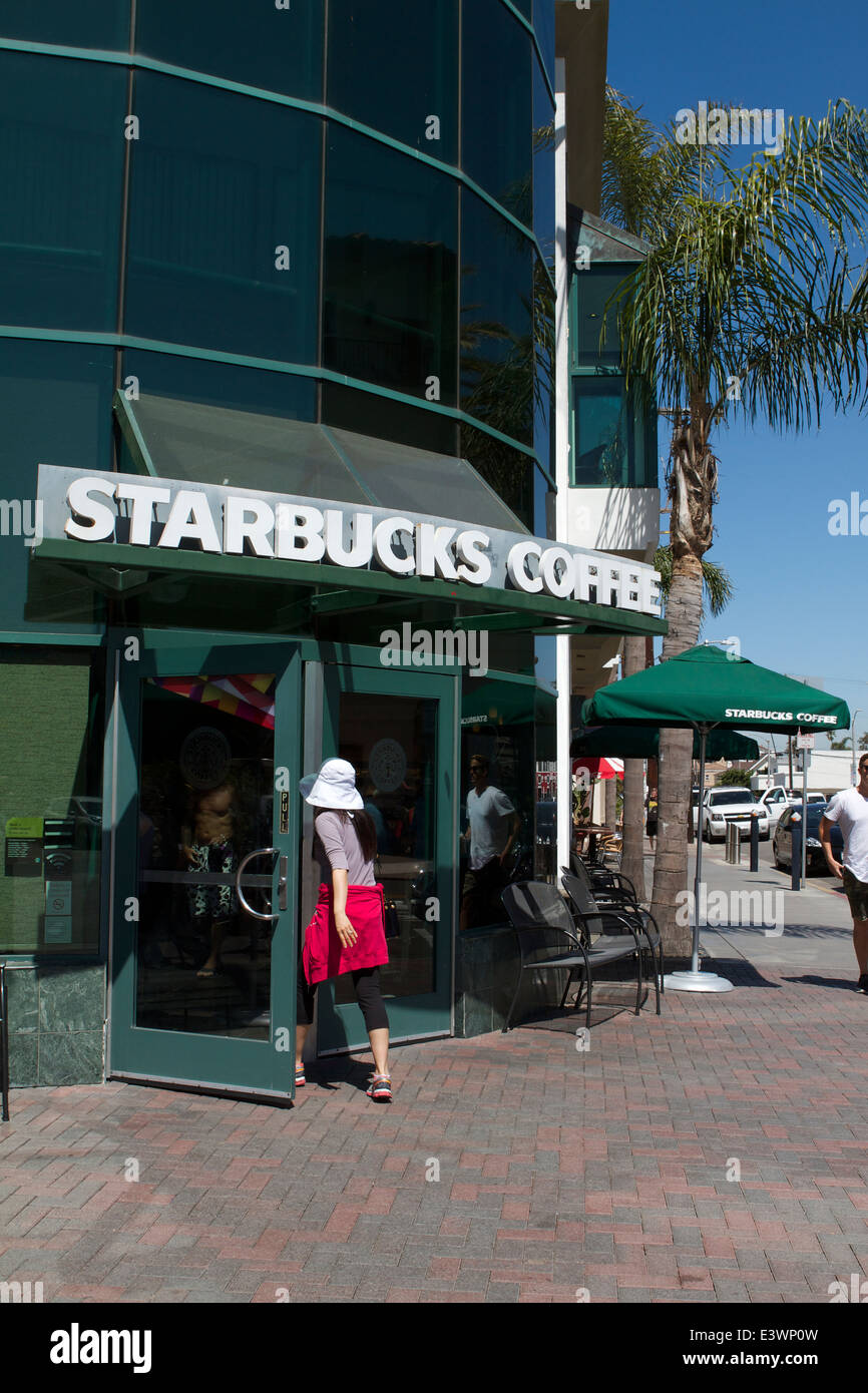 A street level view of the exterior of a Starbucks cofee shop in ...
