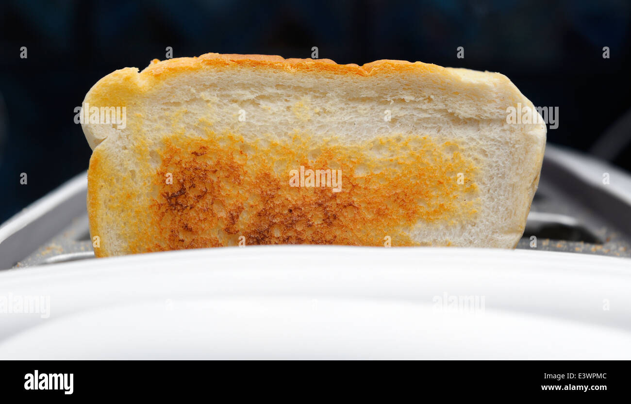 A slice of toast popped up from inside a toaster Stock Photo - Alamy