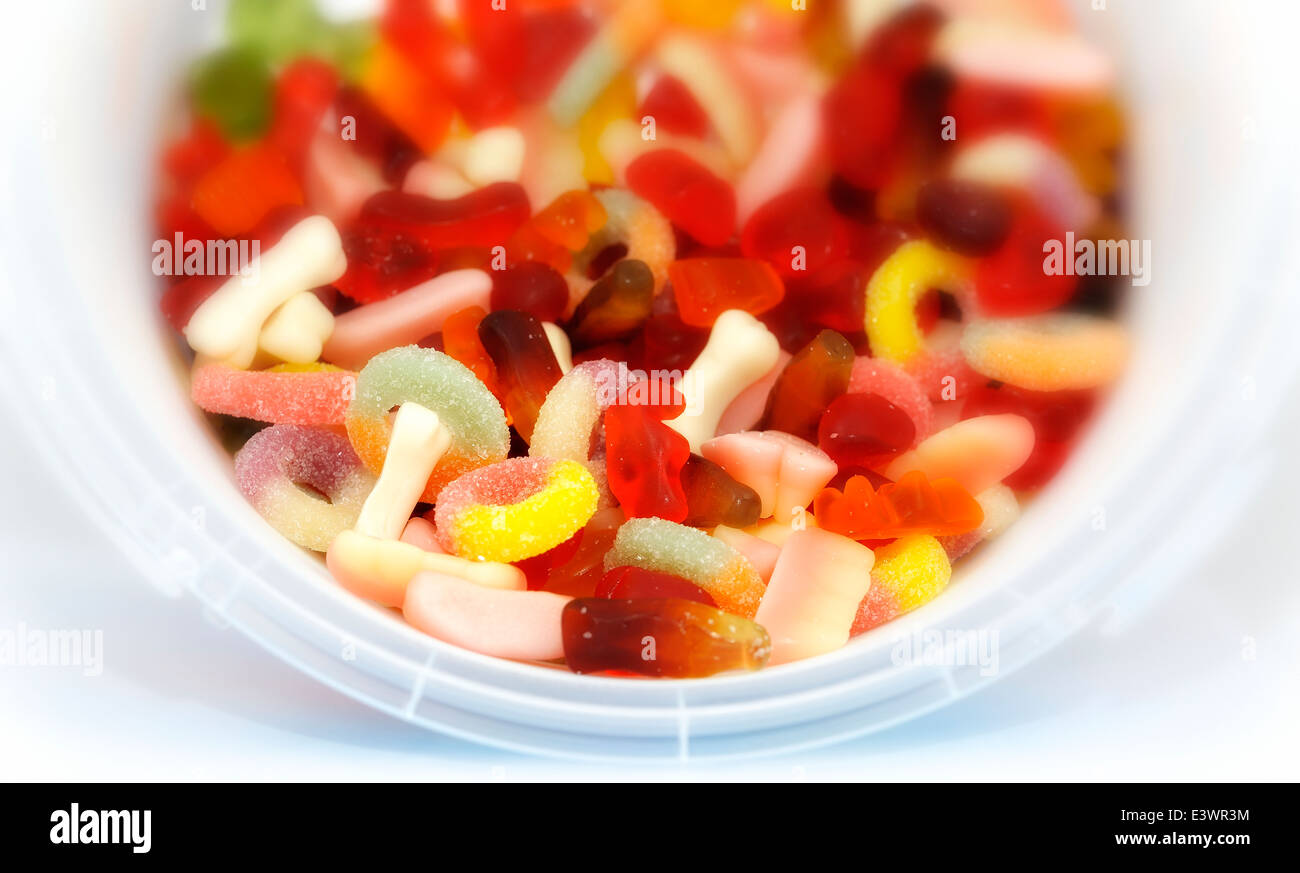 A bucket of mixed candy sweets on a white background Stock Photo - Alamy