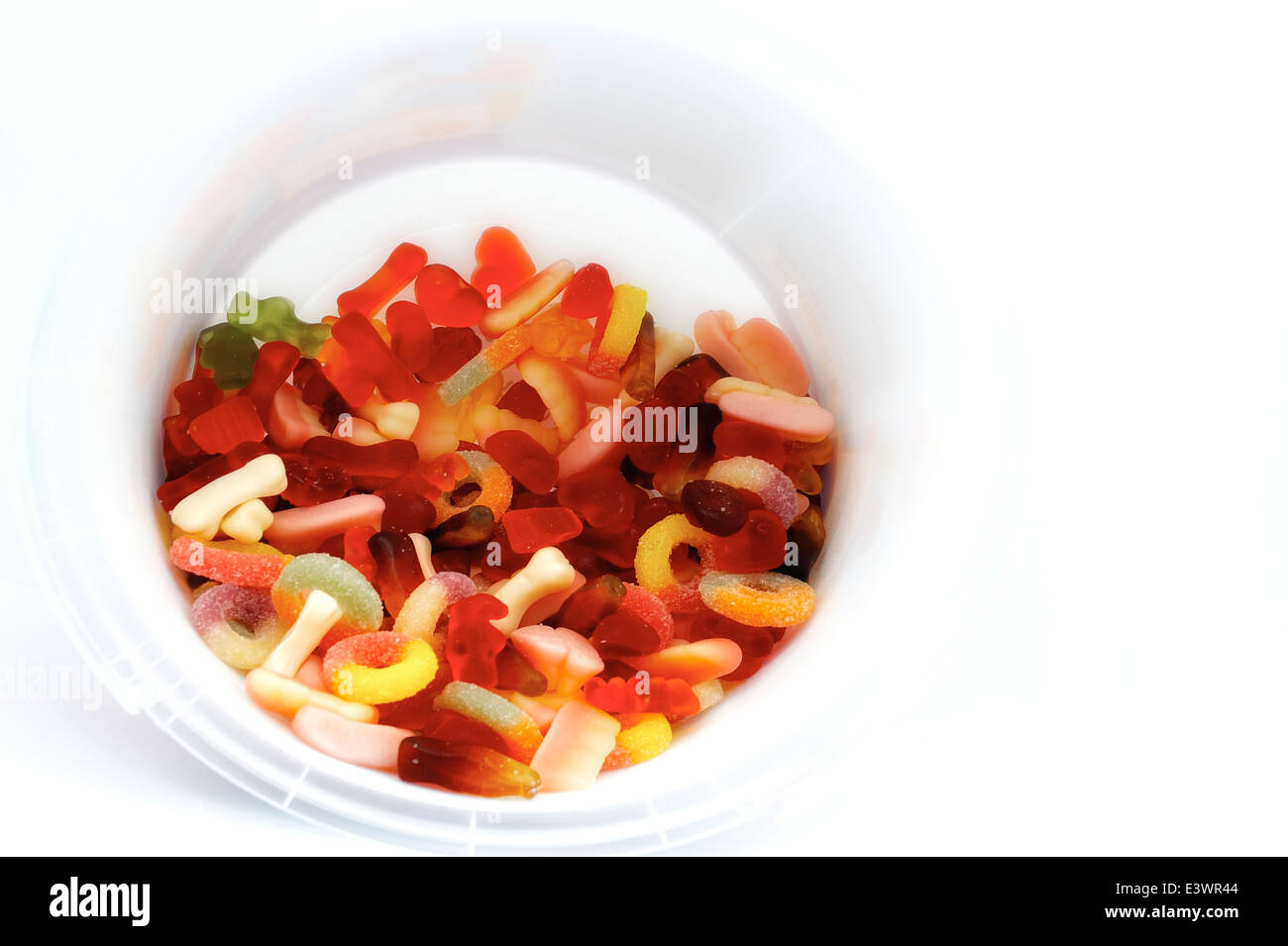 A bucket of mixed candy sweets on a white background Stock Photo - Alamy