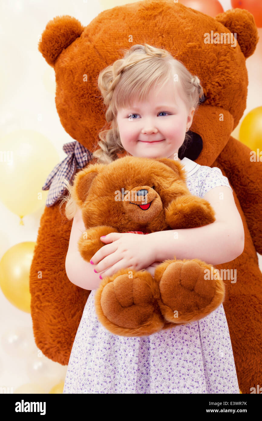 Charming little girl hugging favorite toy Stock Photo - Alamy