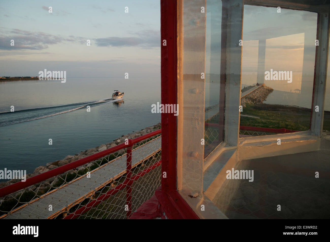Lighthouse view at Bonaventure with boat heading out for evening catch ...
