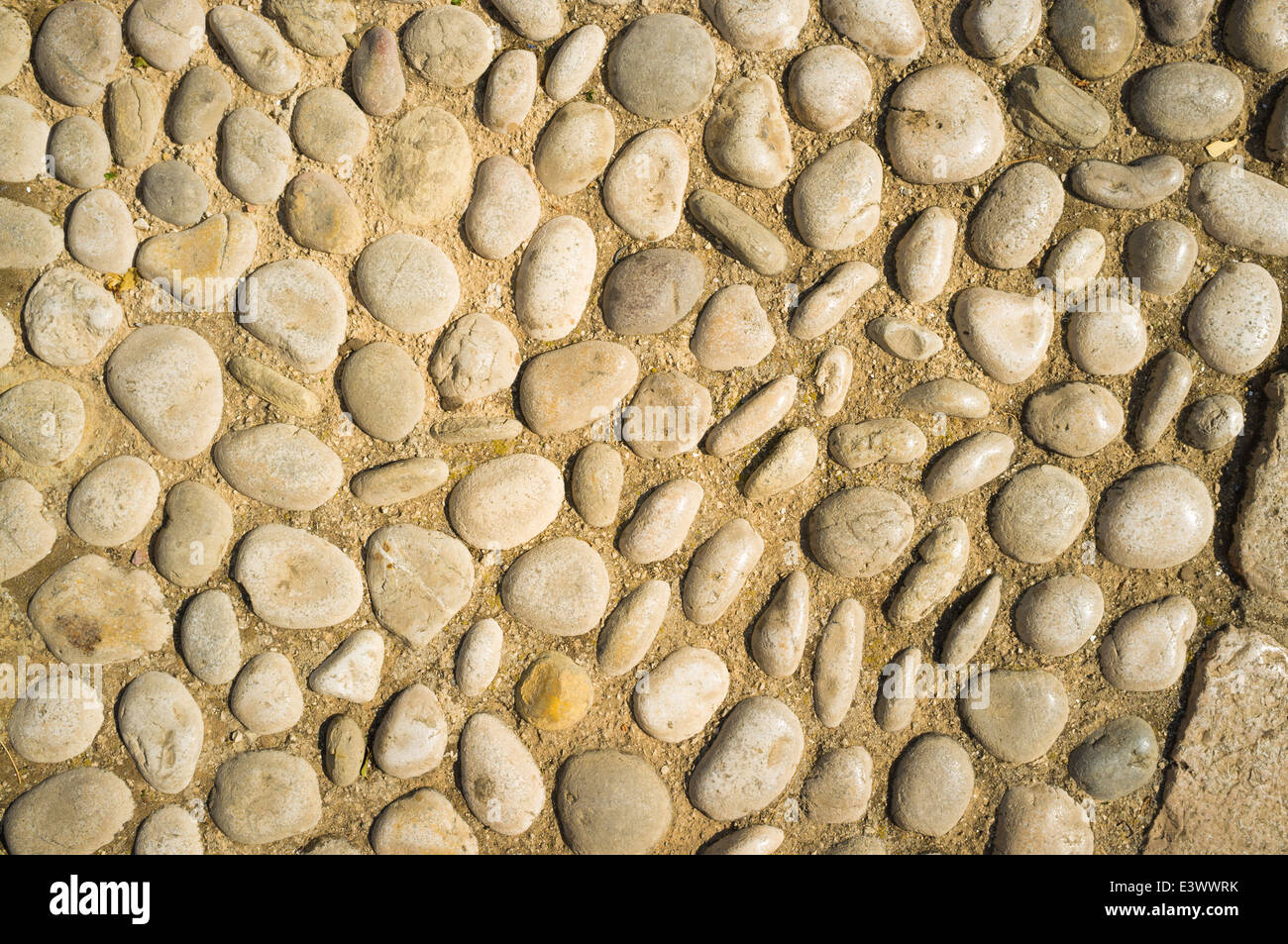 Full frame take of a sidewalke paved with beach pebbles Stock Photo - Alamy