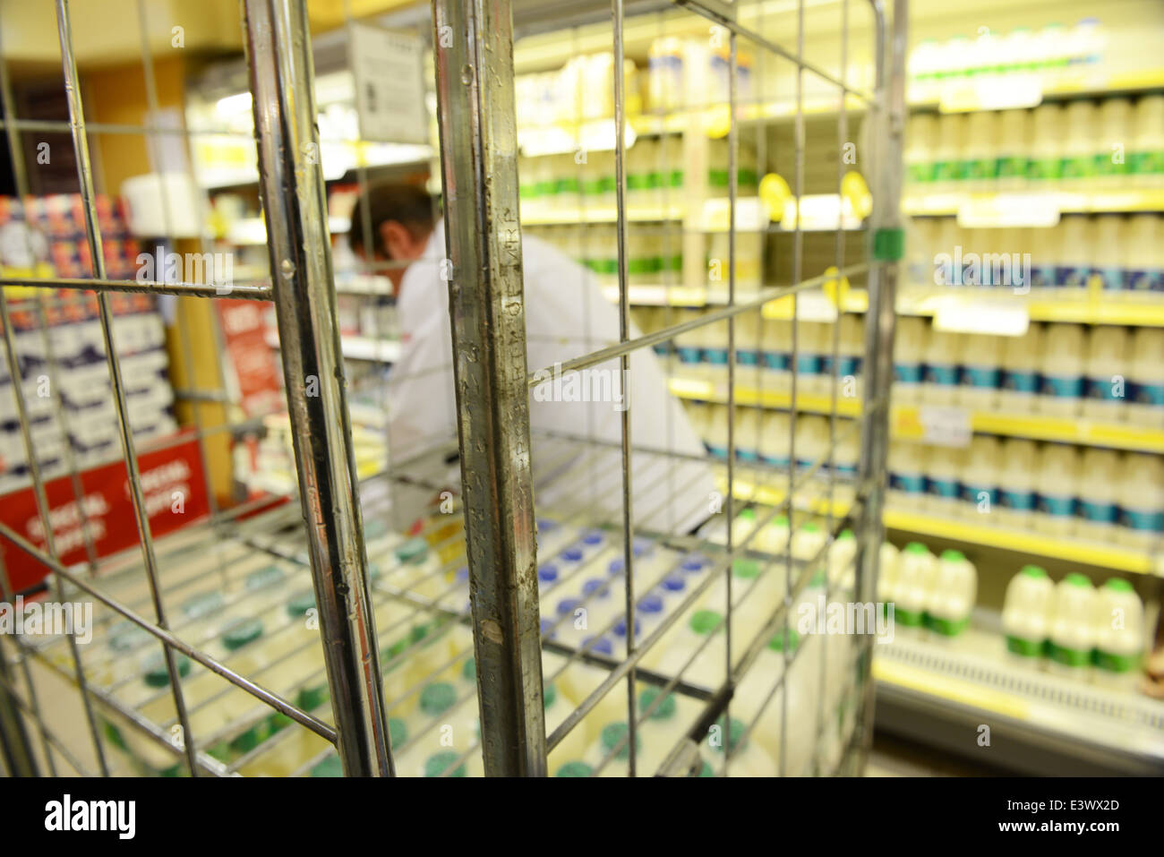 Supermarket staff replenishing shelf Stock Photo - Alamy