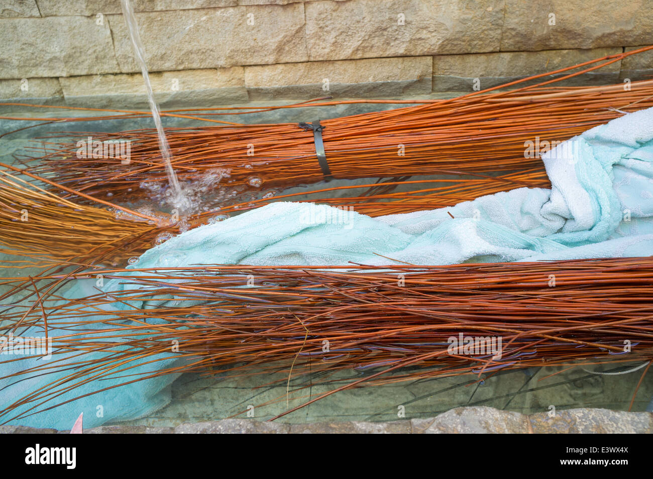 Wicker being soaked in running water to make it flexible Stock Photo ...