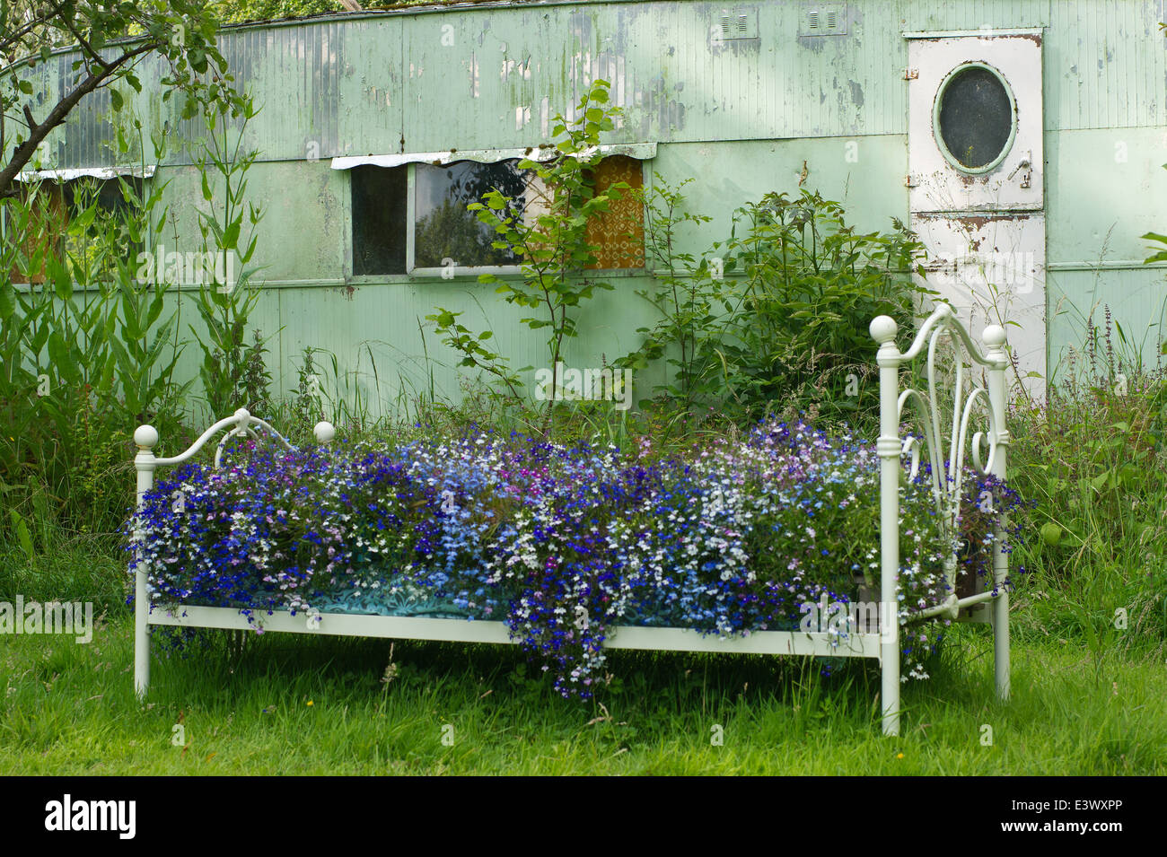 A bed of flowers in front of an old caravan at Heartfelt Garden at ...