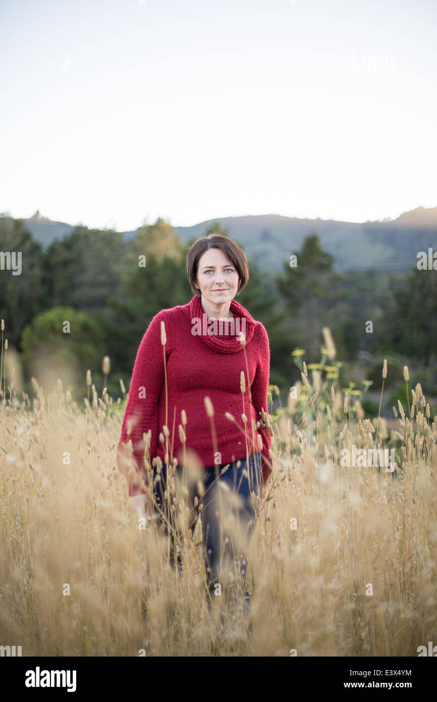 Woman walking through field oats hi-res stock photography and images ...