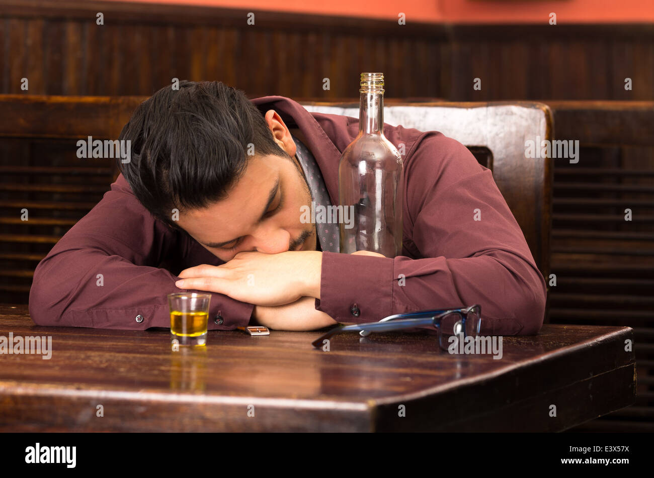 man in suit drinking alcohol shot Stock Photo - Alamy