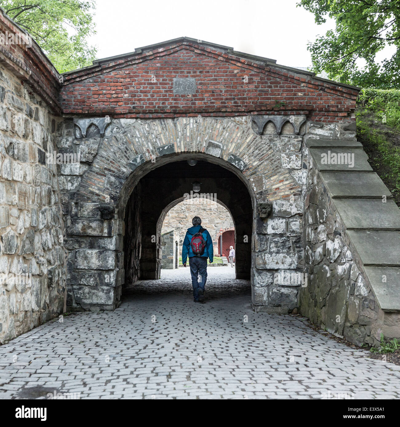 Man walking under arch in Norway Stock Photo - Alamy