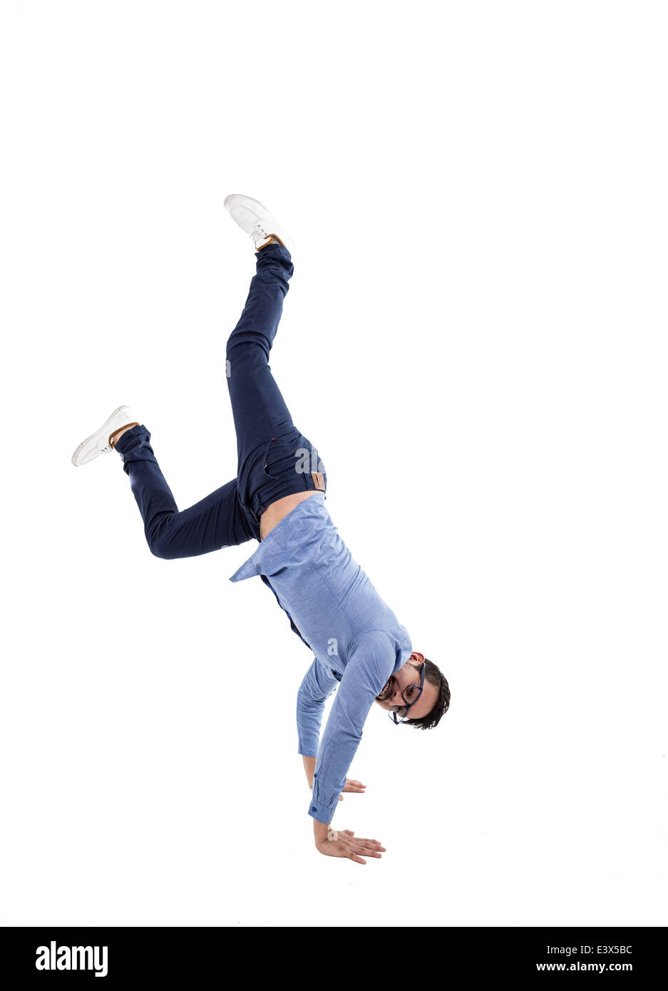 young hispanic man with blue shirt and glasses doing cartwheel Stock ...