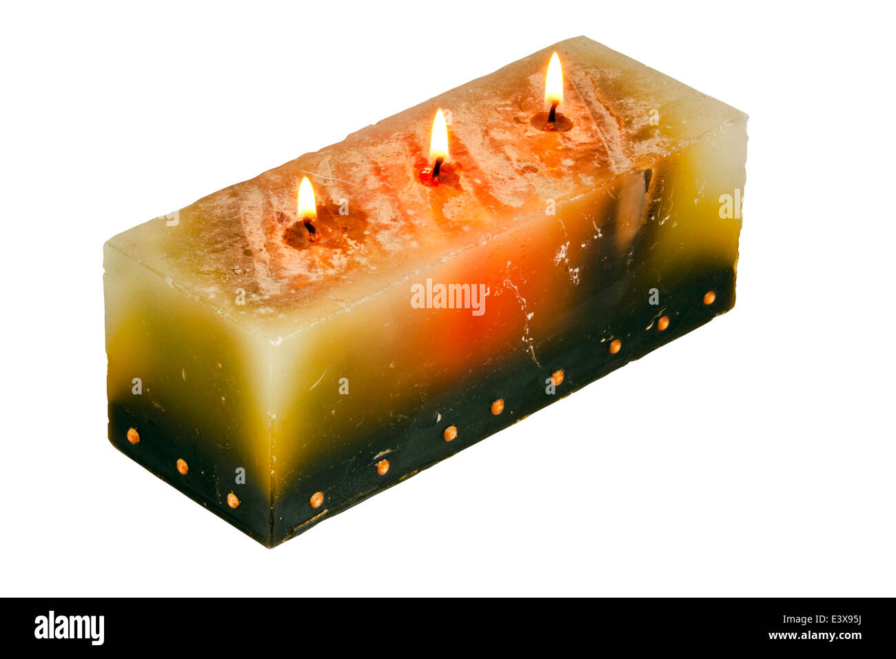 large rectangular candle with three lighted wicks Stock Photo - Alamy