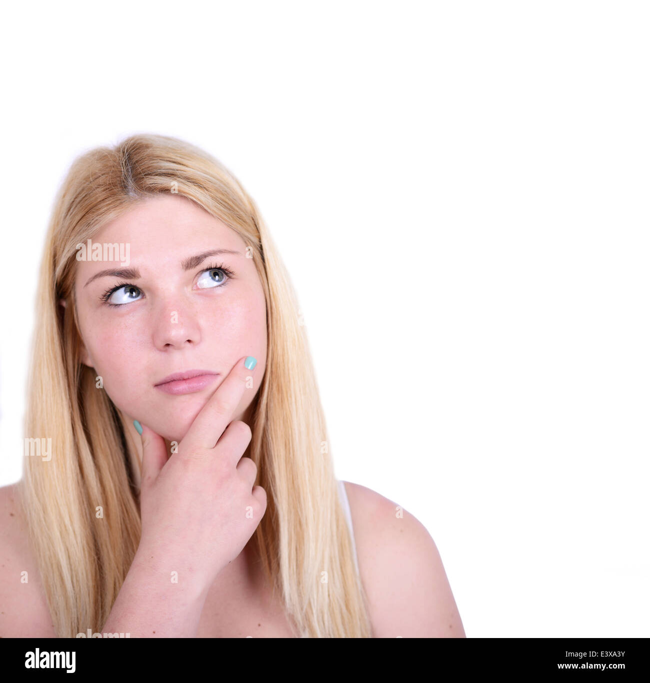 Portrait of beautiful girl thinking and looking up against white ...
