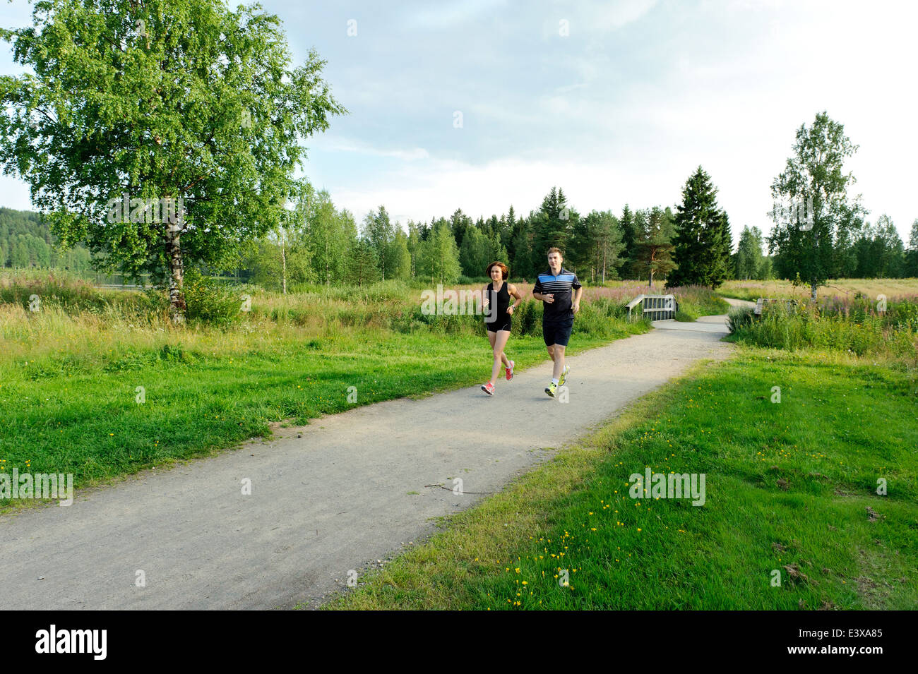 Young couple running outside Stock Photo - Alamy