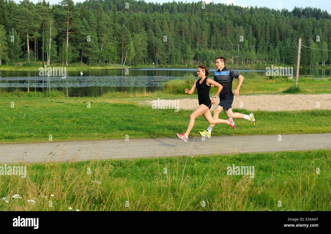 Young couple running outside Stock Photo - Alamy