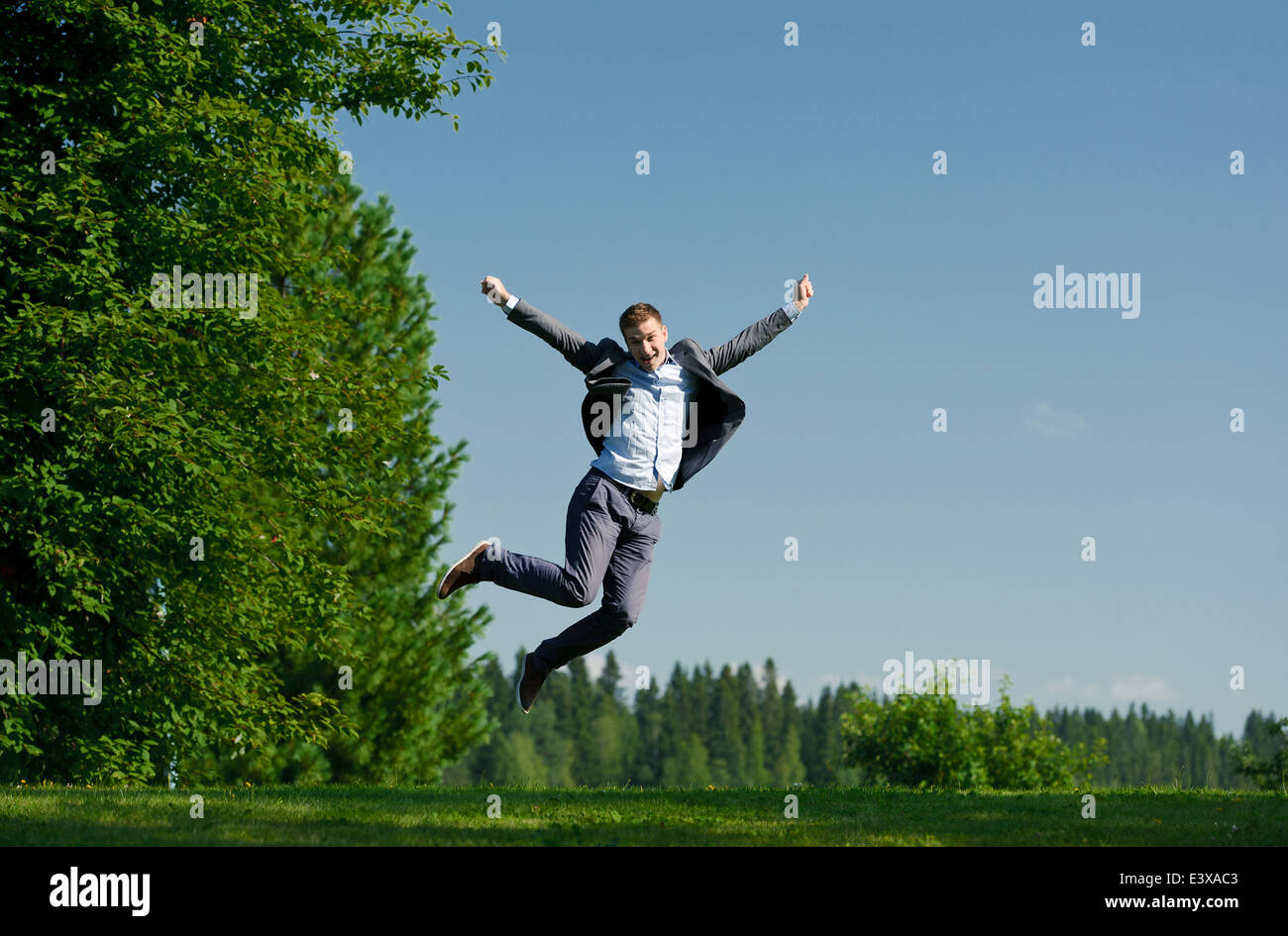 Young man jumping outside Stock Photo - Alamy