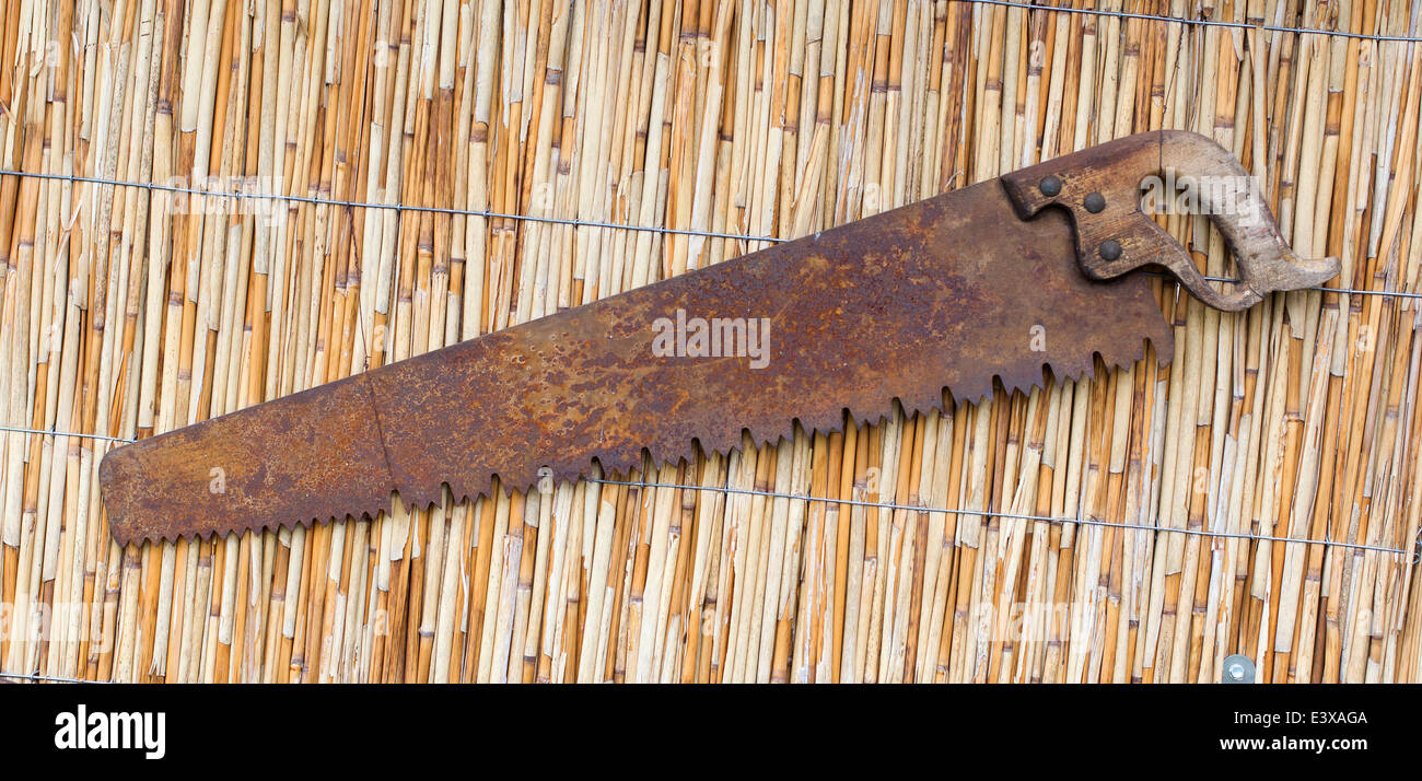 Very old rusted saw with wooden handle Stock Photo - Alamy