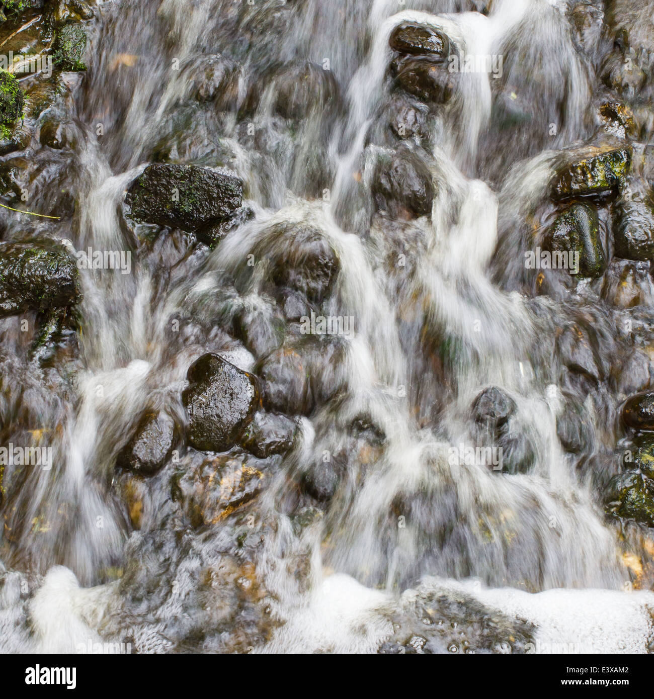 Water flowing over big stones, square crop Stock Photo - Alamy