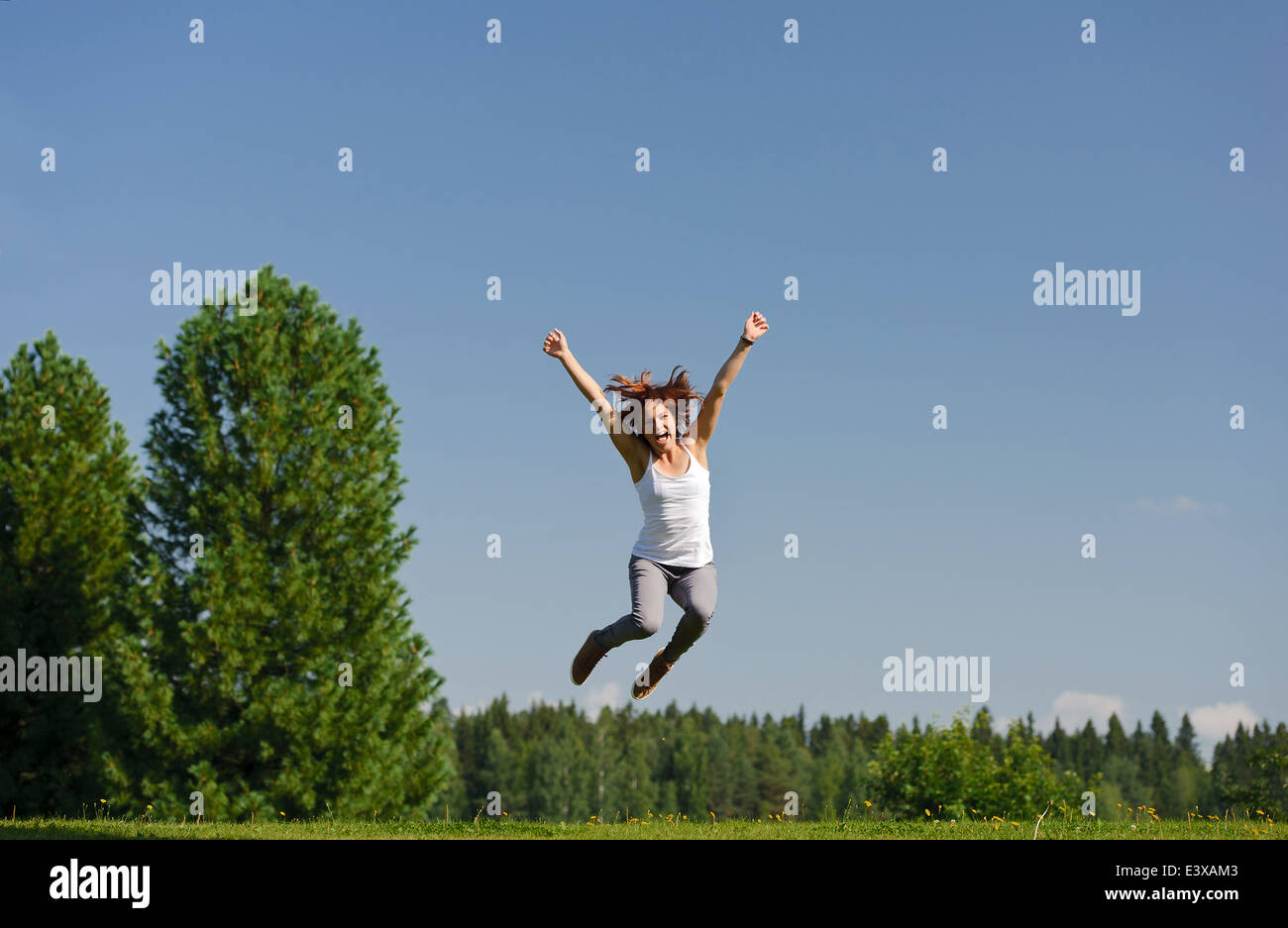 Young woman jumping outside Stock Photo - Alamy