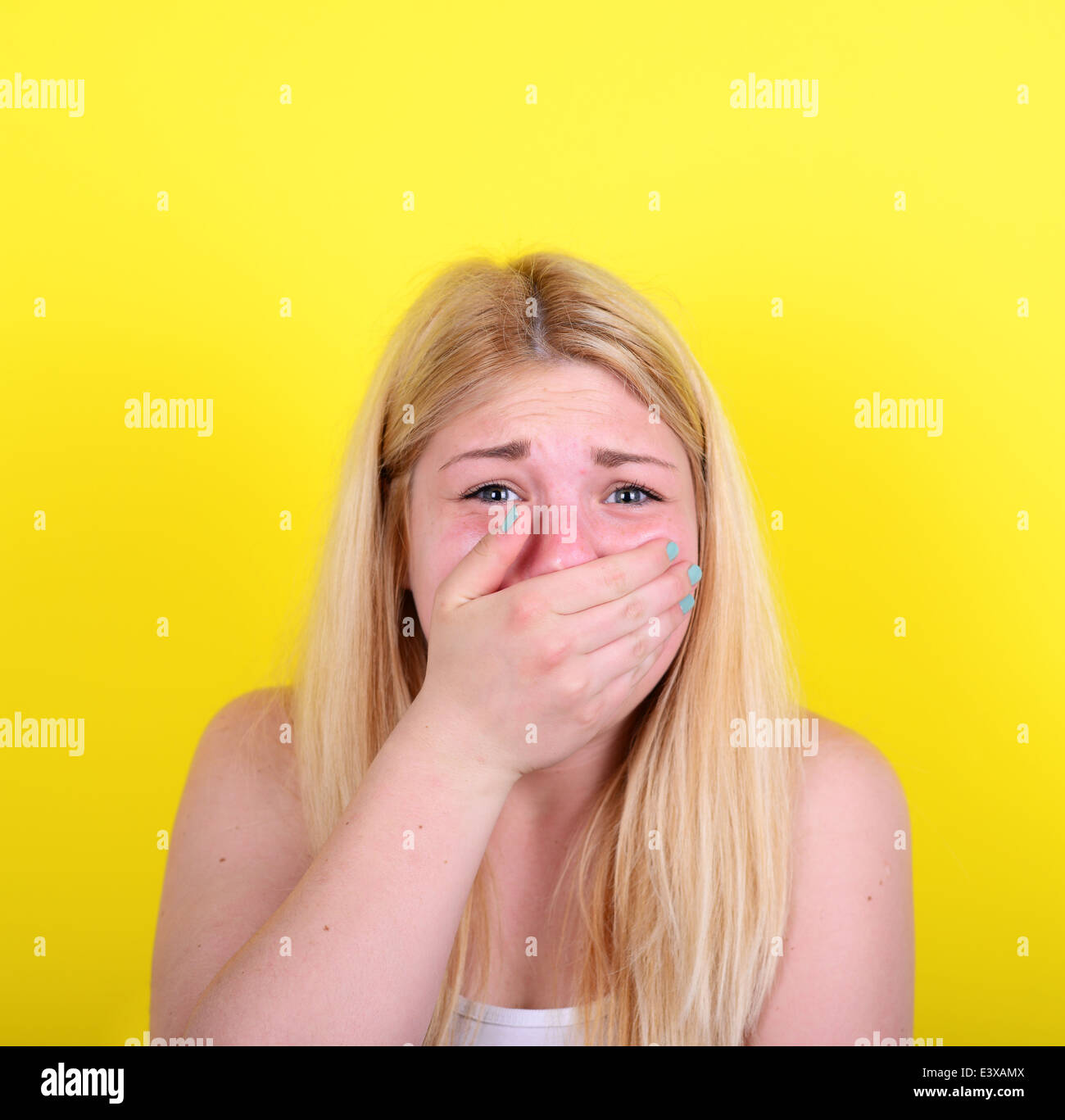 Portrait of scared girl against yellow background Stock Photo - Alamy