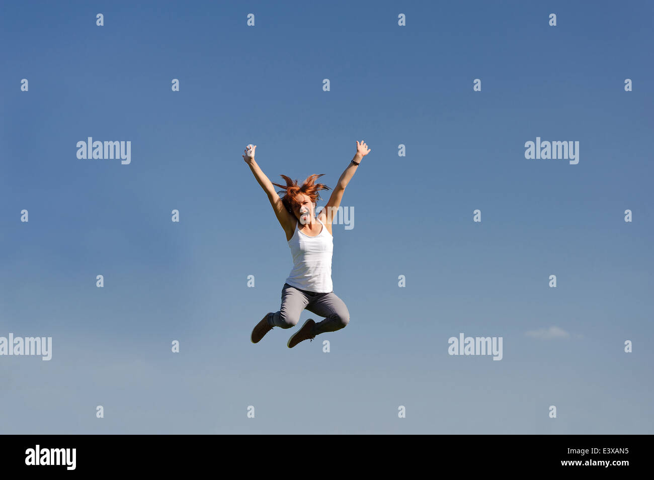 Young woman jumping outside Stock Photo - Alamy