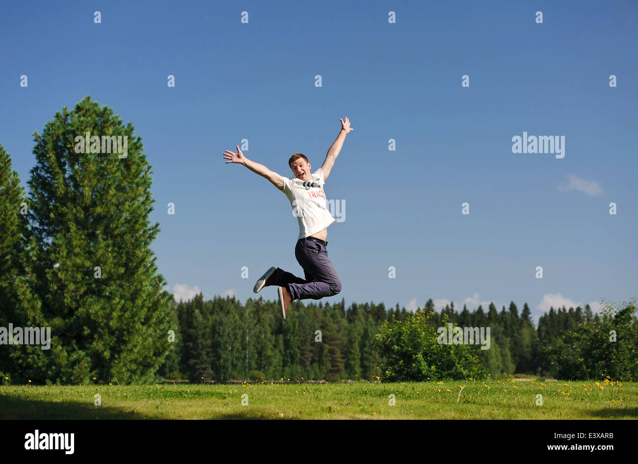 Young man jumping outside Stock Photo - Alamy