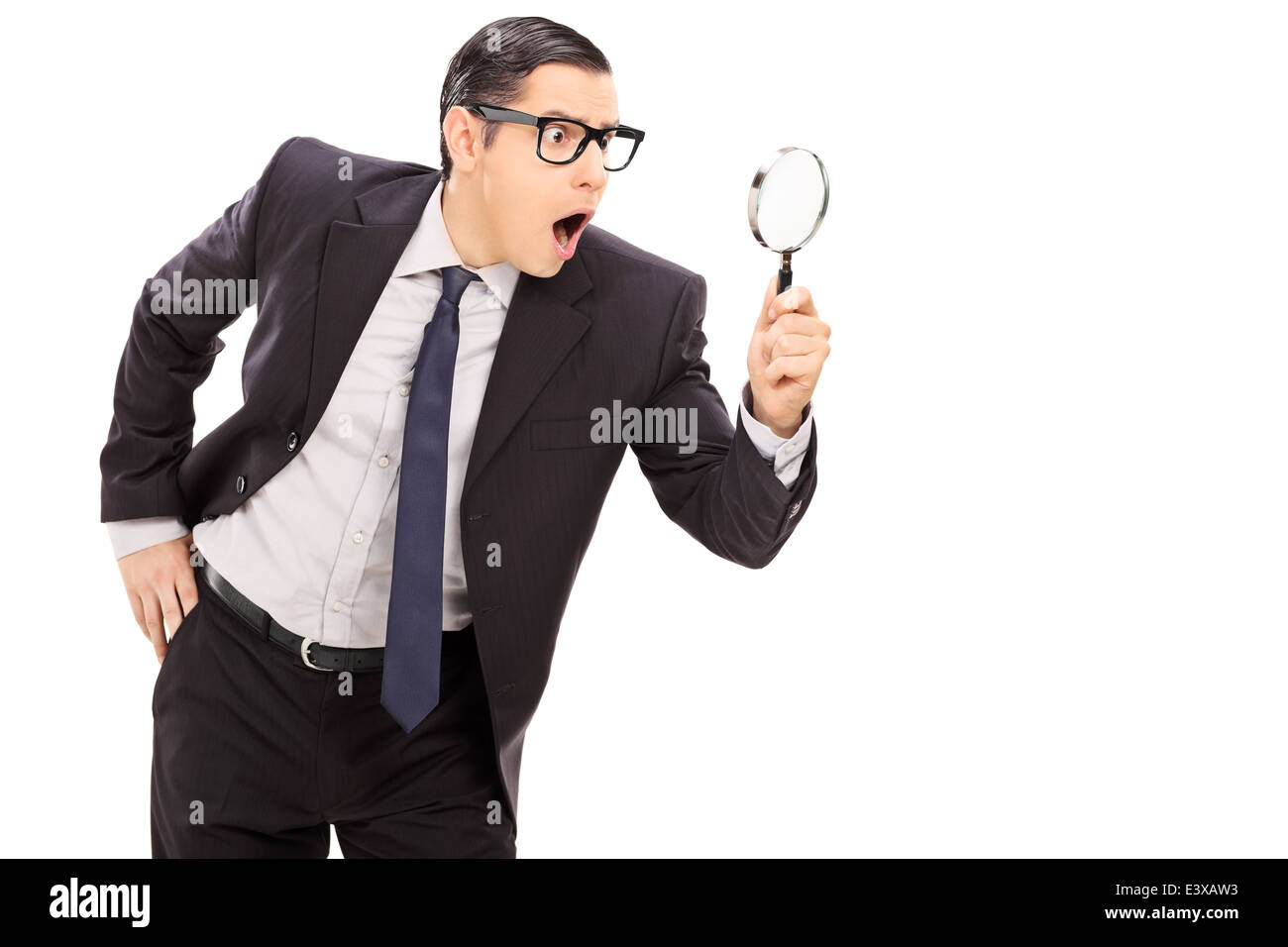 Shocked businessman looking through a magnifier Stock Photo - Alamy