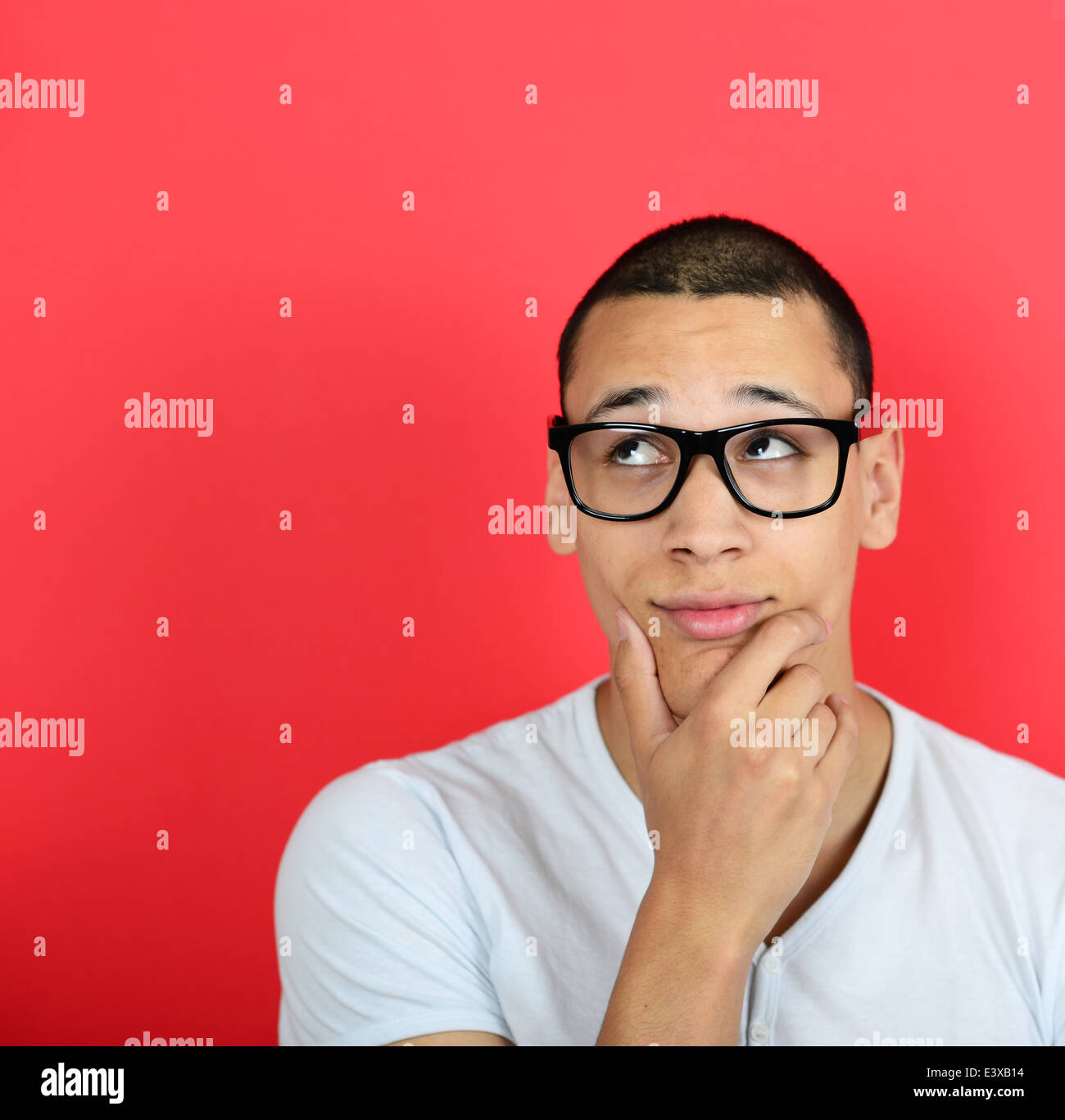 Portrait of a funny businessman with fingers on chin while thinking ...