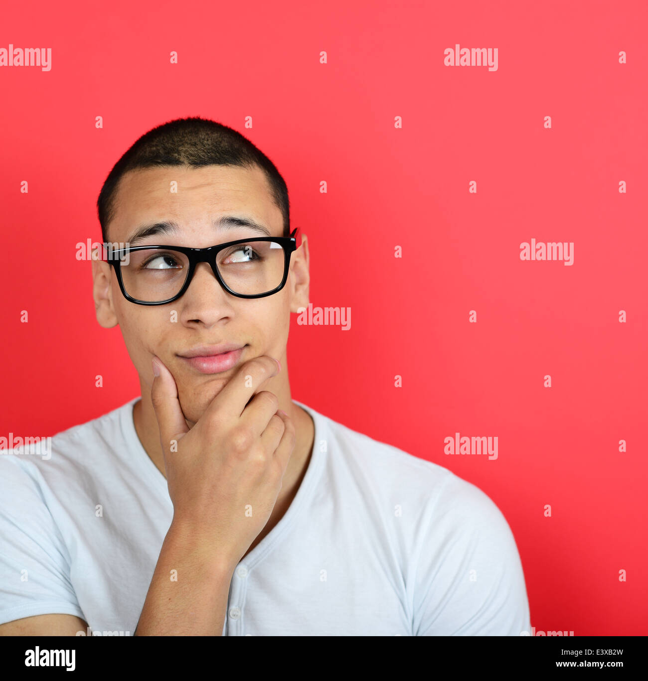 Portrait of a funny businessman with fingers on chin while thinking ...