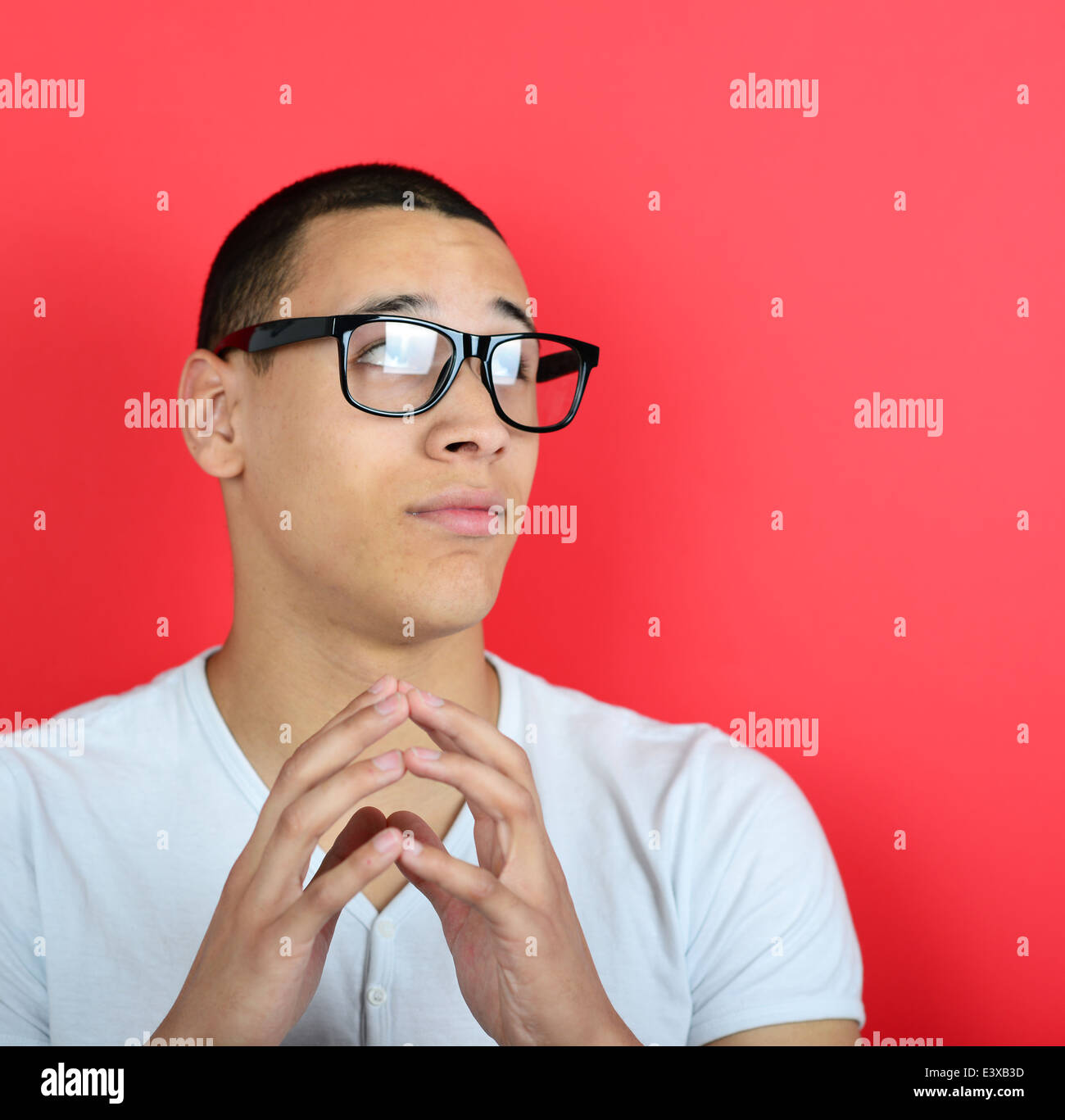 Thinking businessman touching his glasses against brainstorm in grey ...