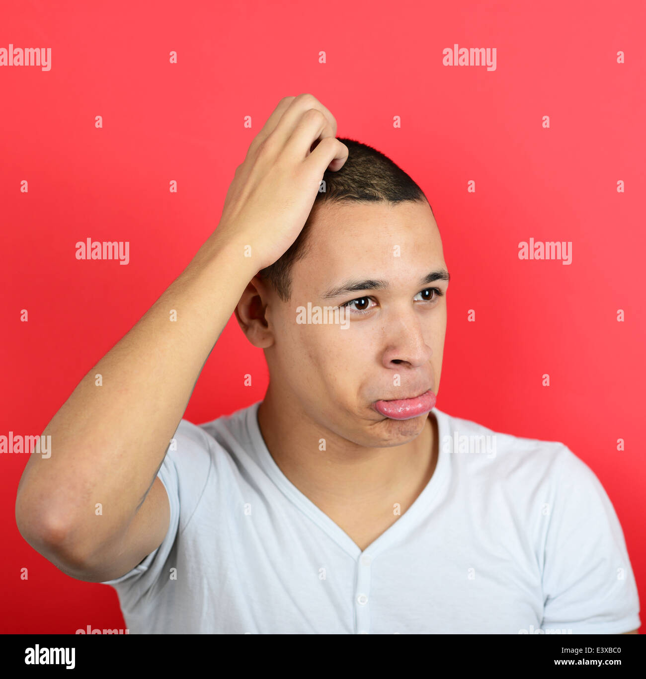 Portrait of clueless man against red background Stock Photo - Alamy