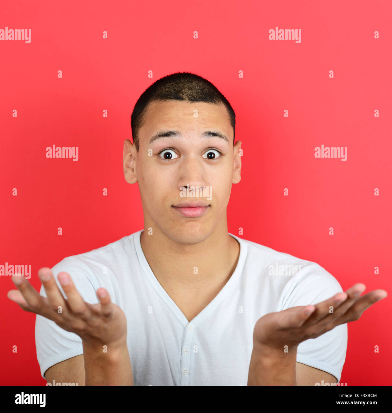 Portrait of clueless man against red background Stock Photo - Alamy