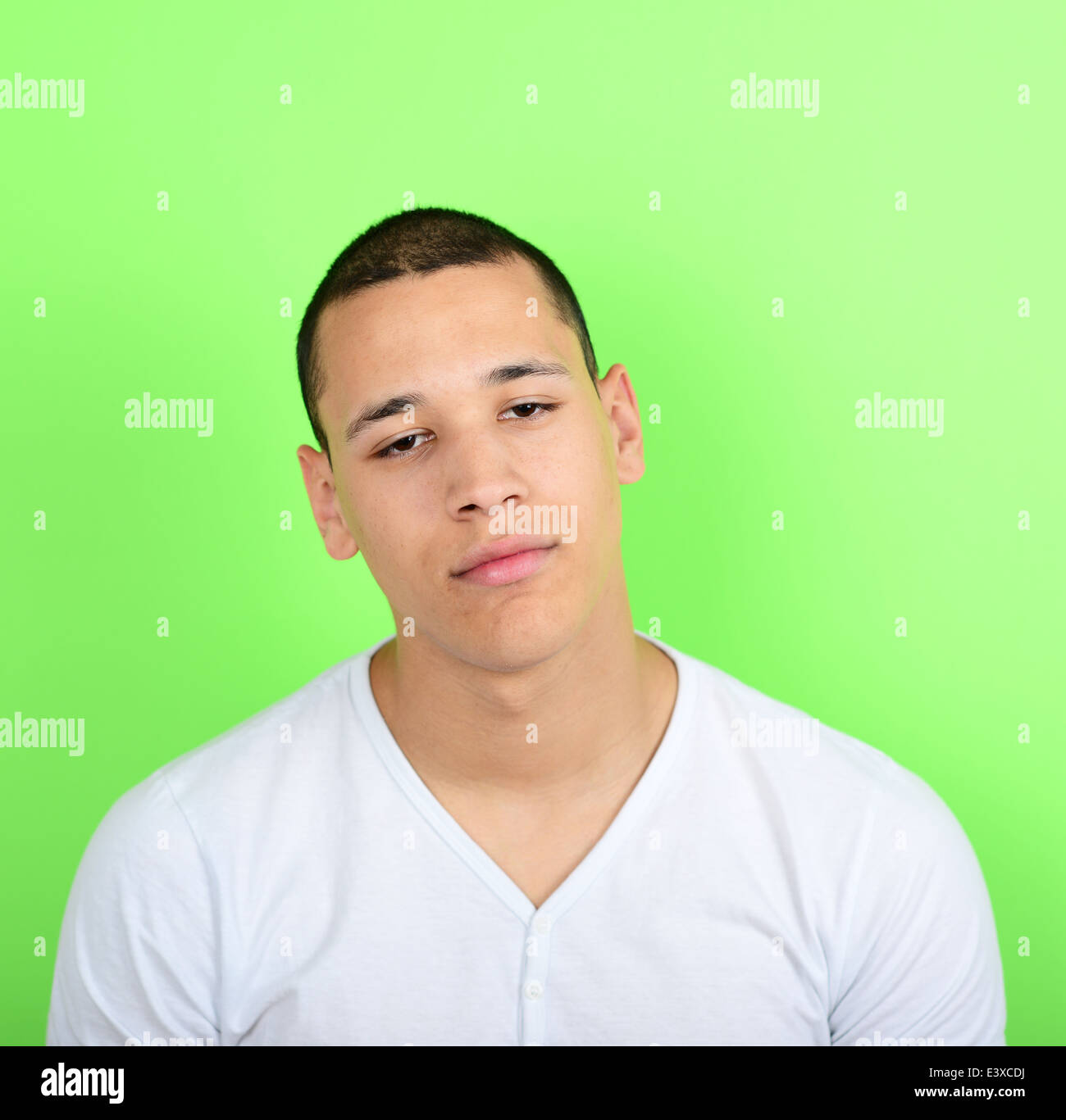 Portrait of tired man against green background Stock Photo - Alamy