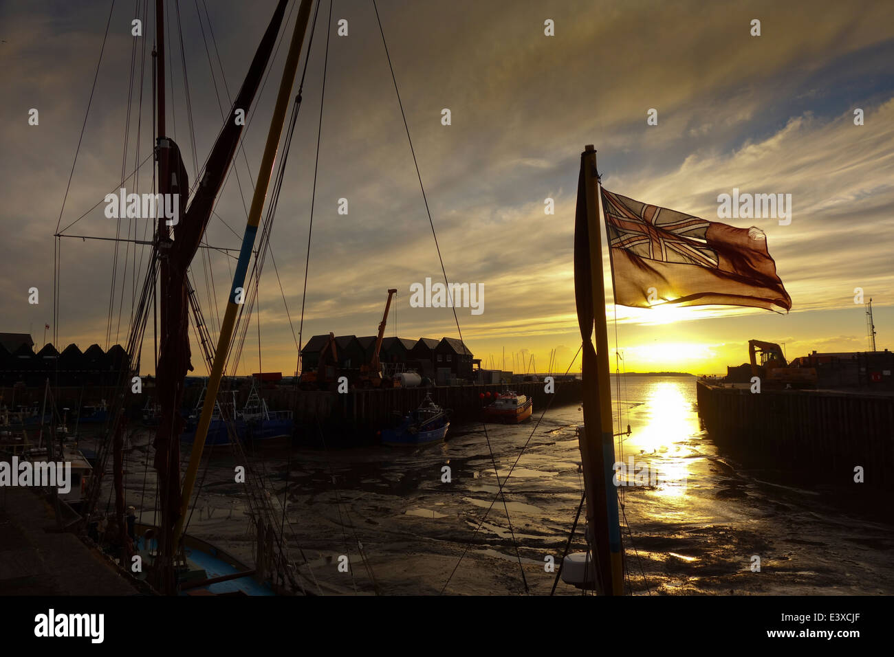 Whitstable harbour sunset low tide Stock Photo - Alamy