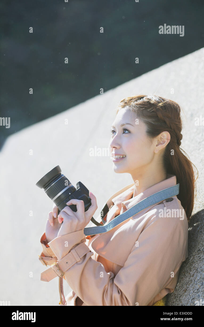 Portrait of Japanese woman with camera smiling Stock Photo - Alamy